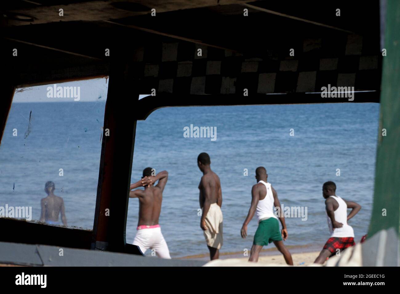 Five men are seen through the window of a boat at Senga Lake Malawi ...
