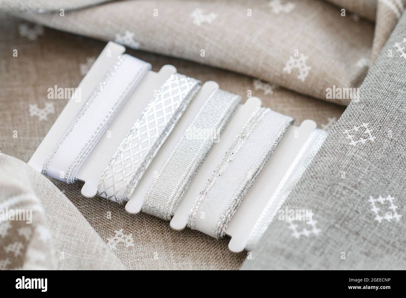 Silver ribbons on grey fabric. Hobby time Stock Photo - Alamy