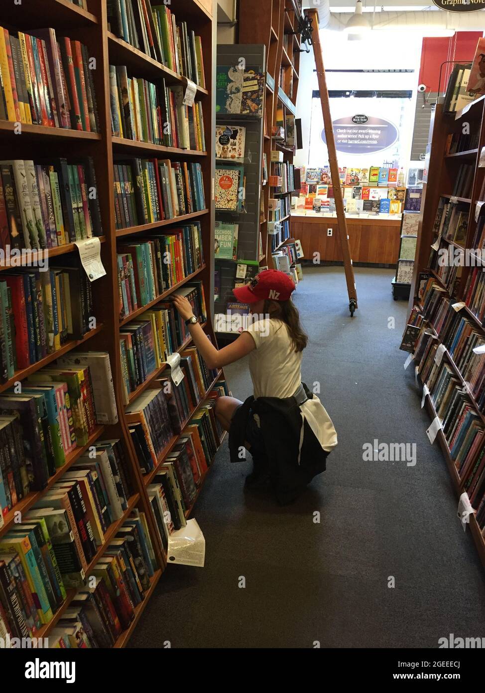 BOSTON, UNITED STATES - Aug 23, 2017: A girl looking through the books ...