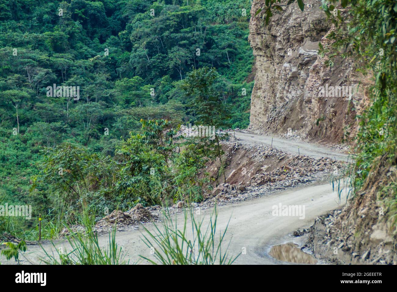 Narrow dangerous road in a valley of Coroico river in Yungas mountains ...