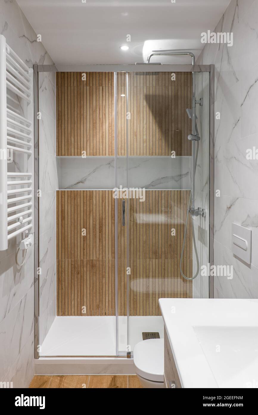 Shower zone with wooden finishing and glass door. Interior of modern ...