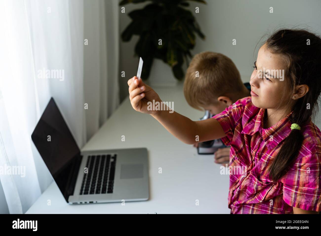 Kids playing with laptop computer at home Stock Photo - Alamy