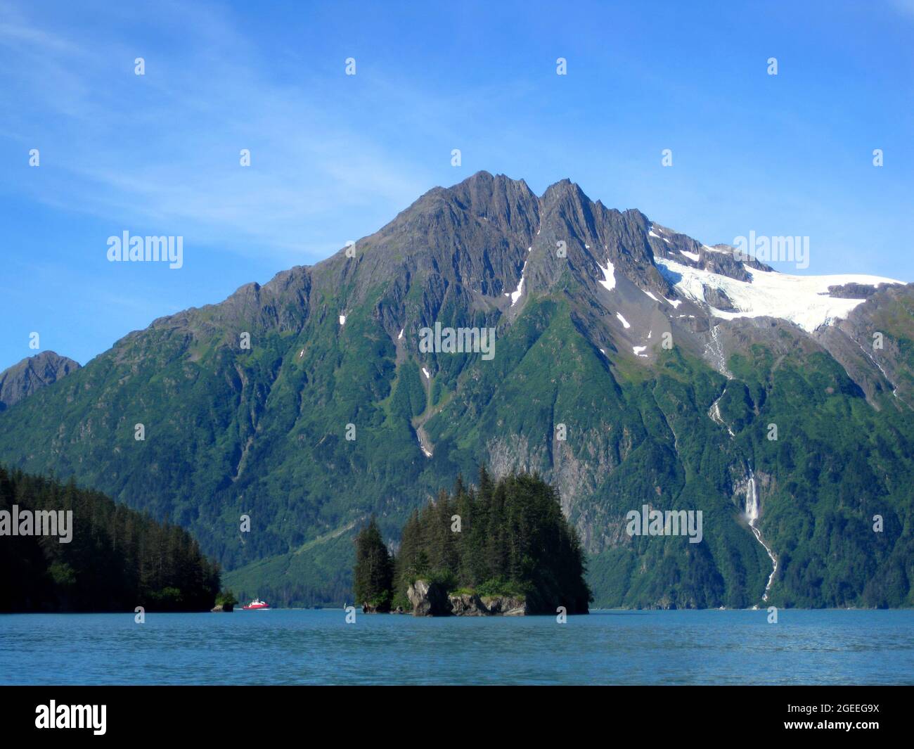 Miniscule boats traverse the Valdez Narrows near Valdez, Alaska ...