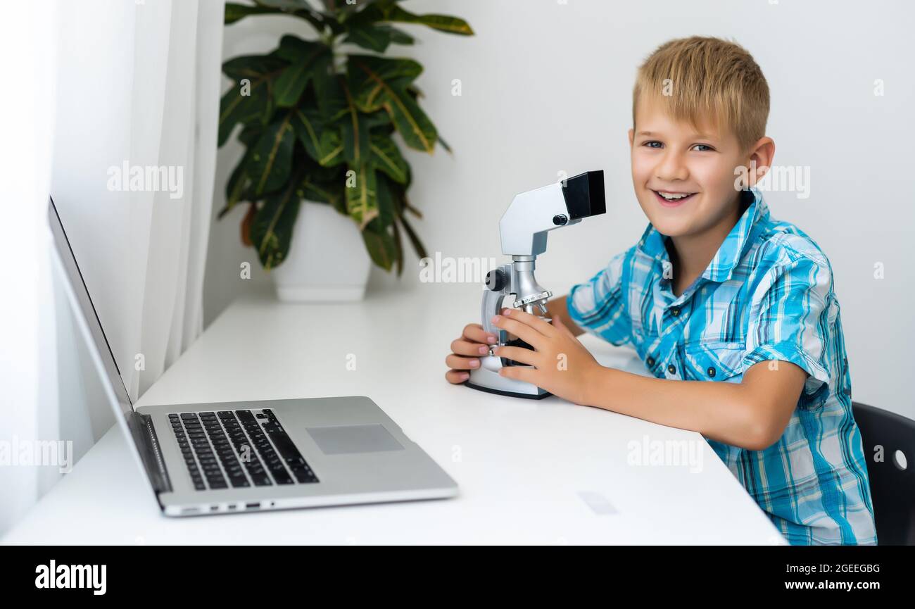 Smart Young Boy Works on a Laptop For His New Project in His Computer ...
