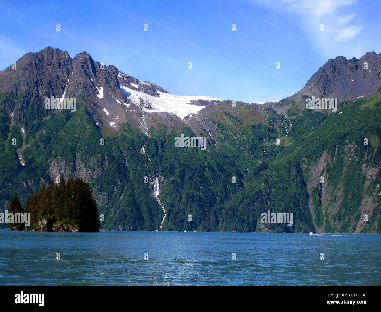 Boats appear tiny compared to the towering majesty of the Chugach ...