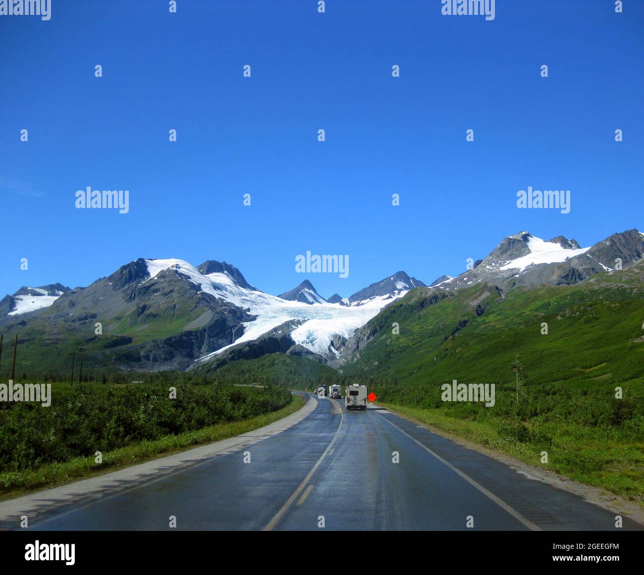 Campers and RVs follow curving road toward a huge Worthington glacier ...