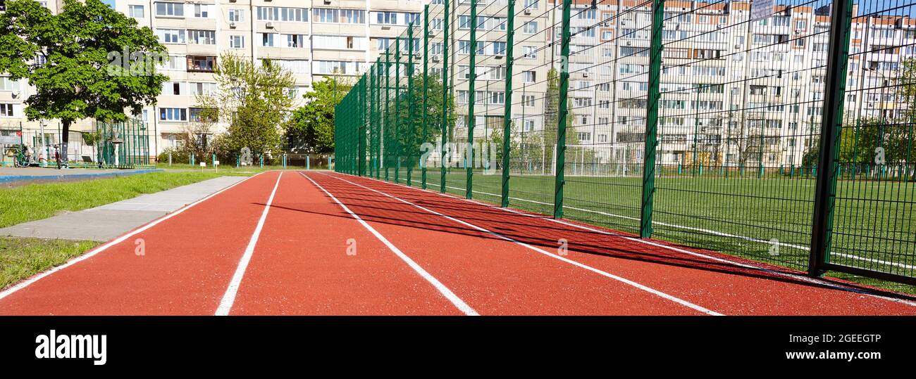 Red treadmill on sport field. Running track on the stadium Stock Photo ...