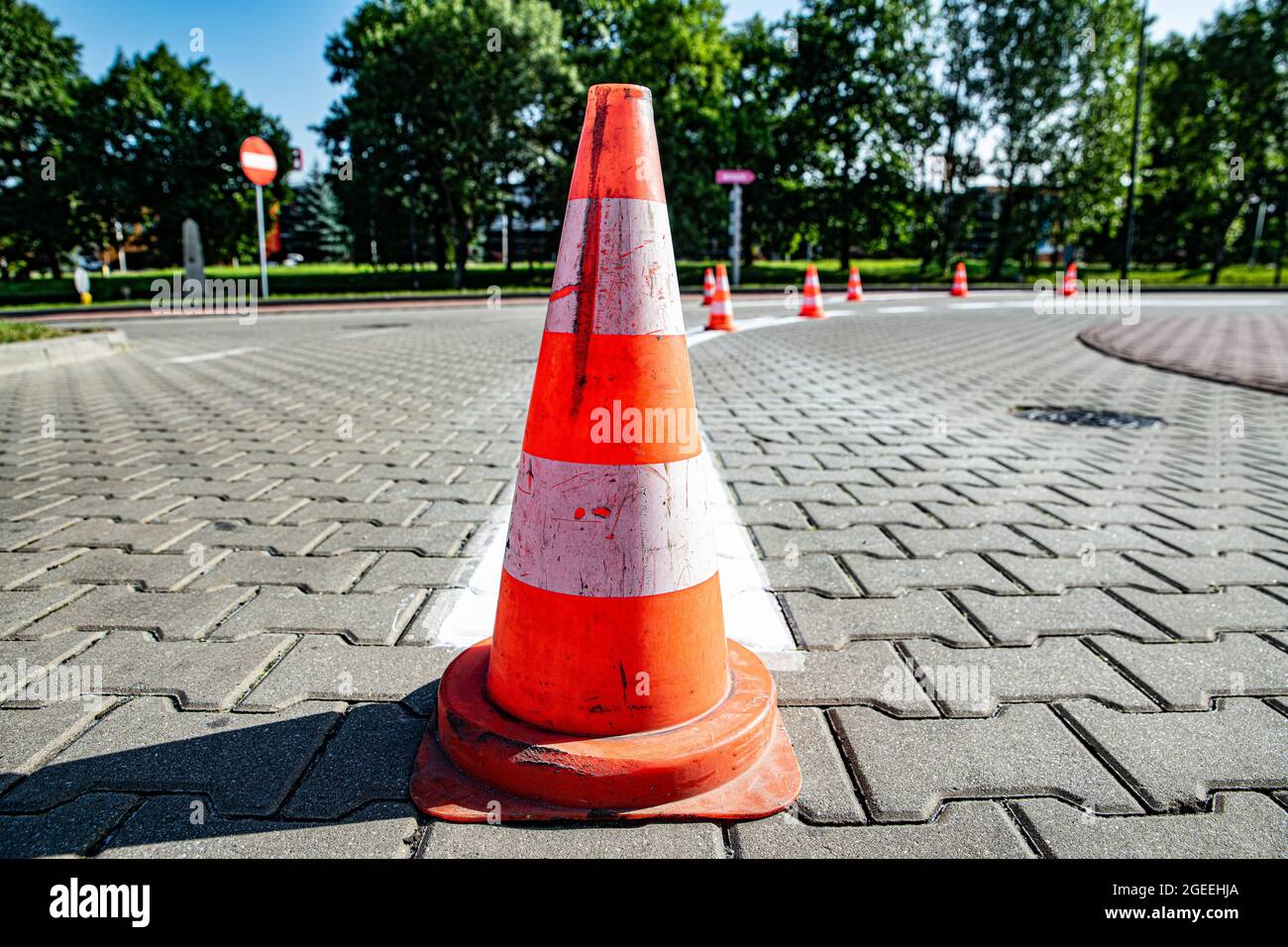 Red cones arranged in the street while stripes are painted on the road ...