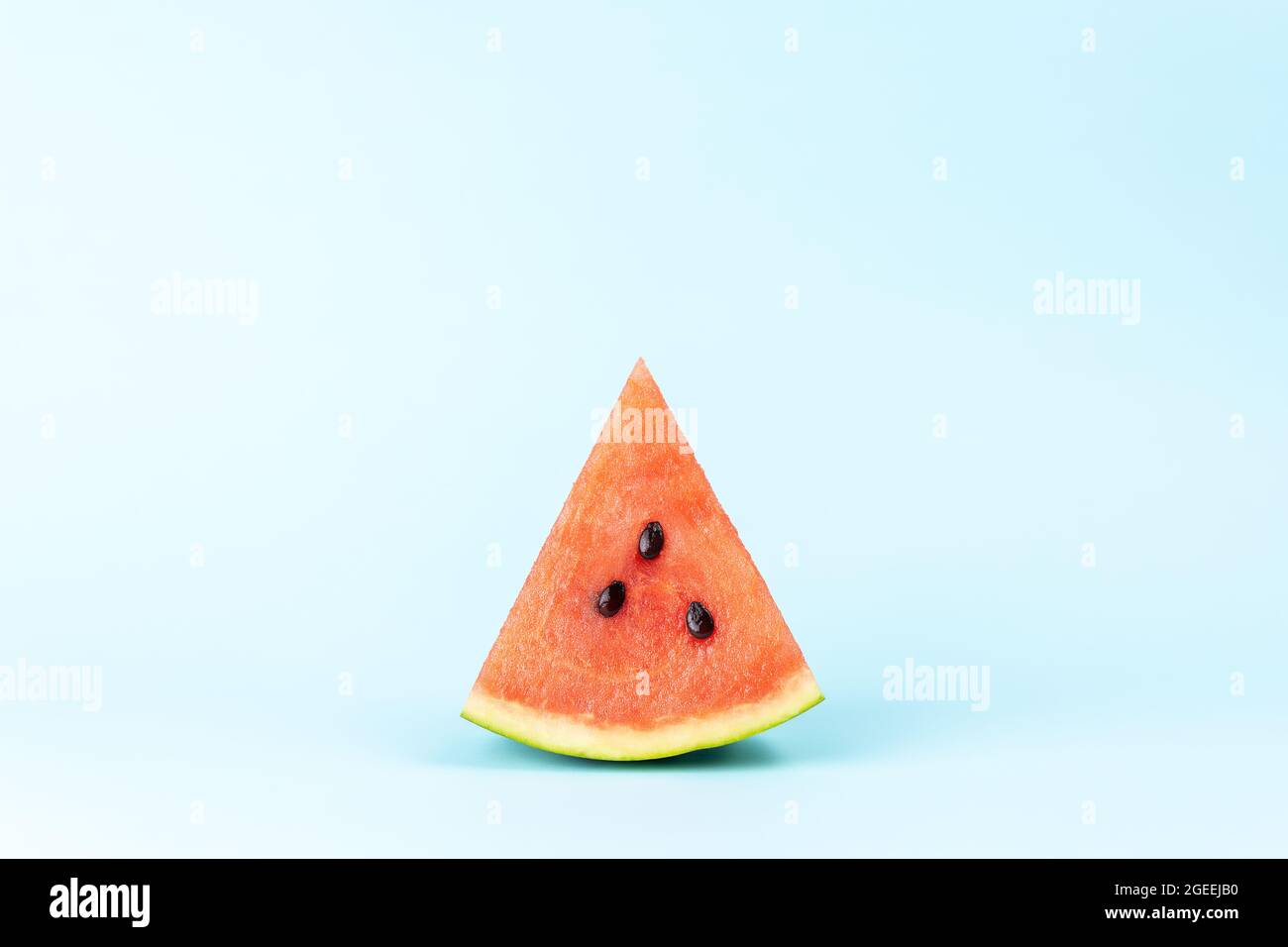 A slice of watermelon on pastel blue background. Summer holiday concept ...