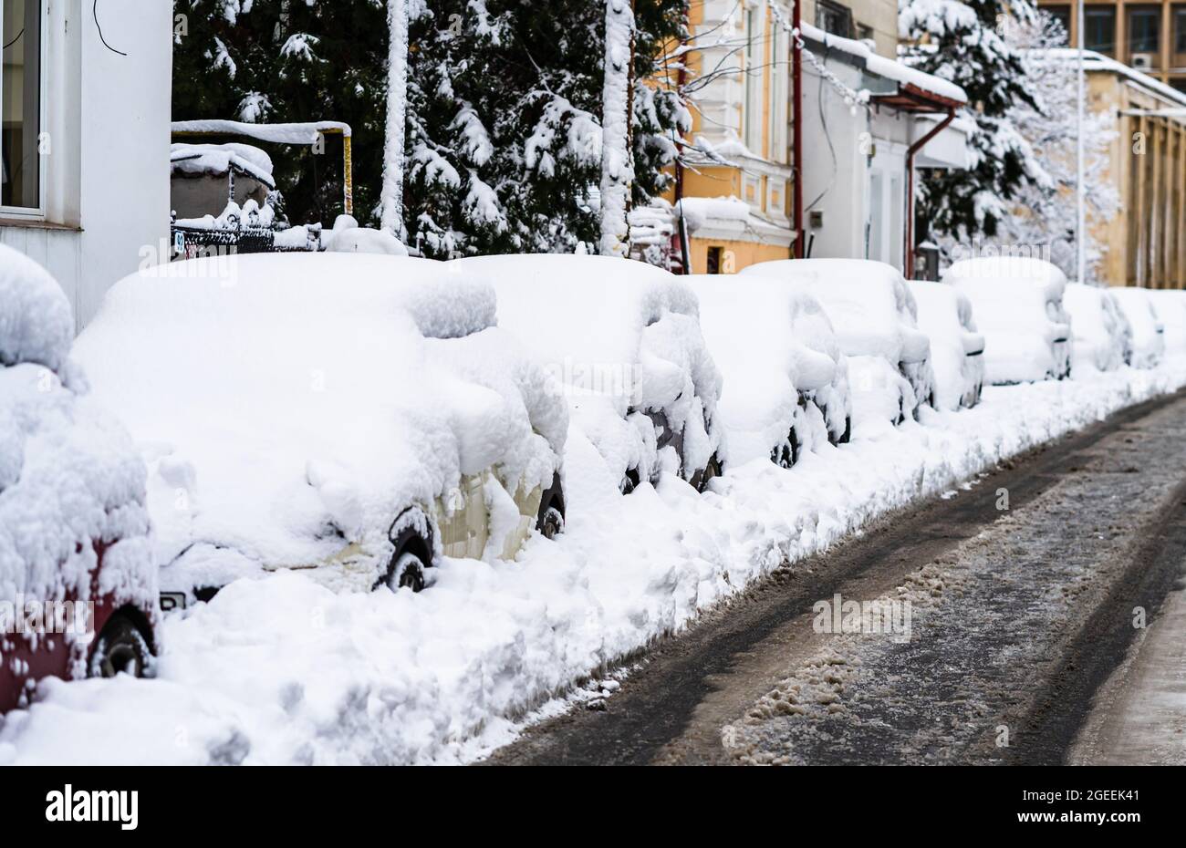 Cars covered with snow from the first snow fall of the year. Winter ...