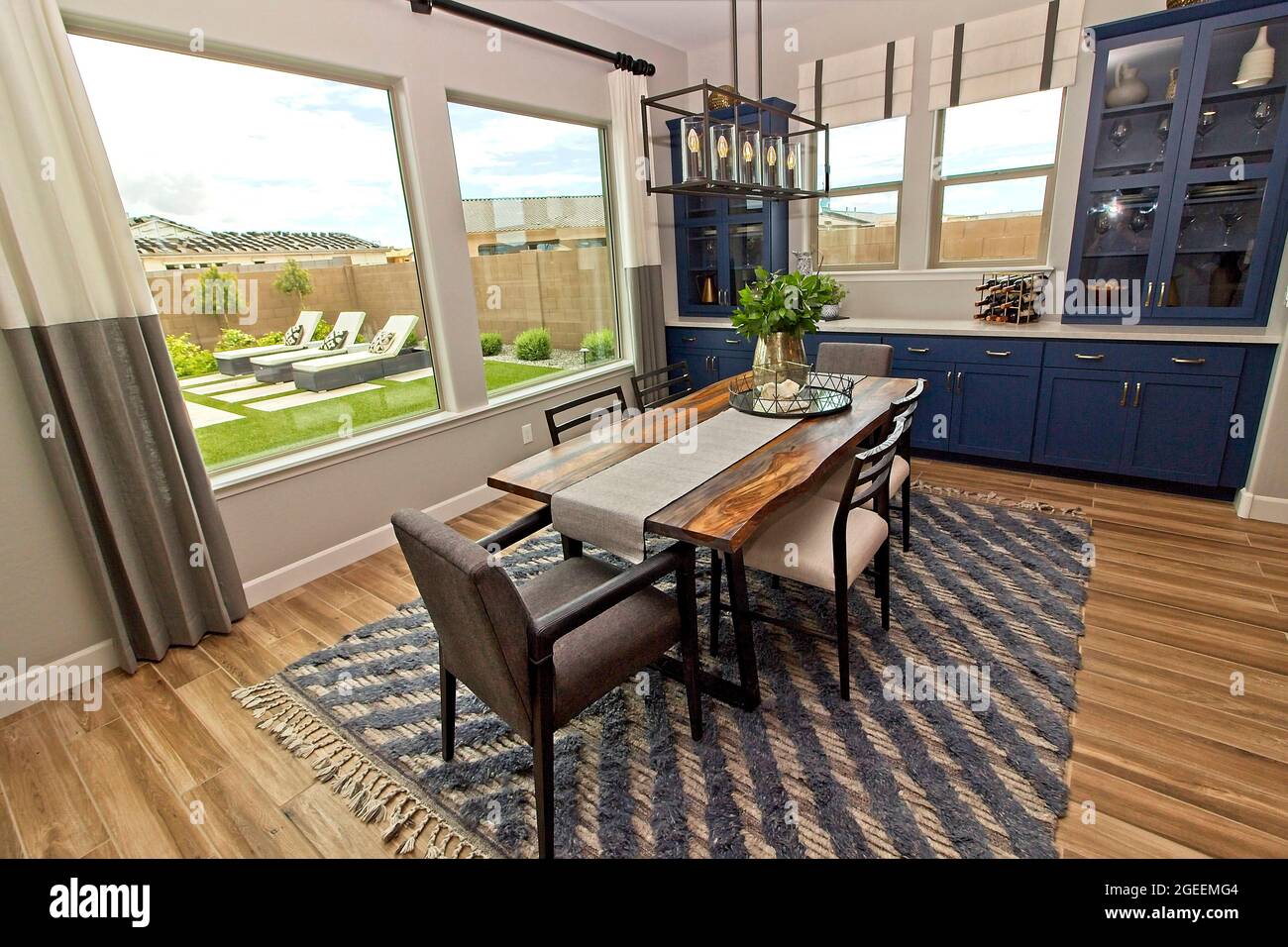 Dining Area With Table, Chairs And Built-In Cabinetry Stock Photo - Alamy
