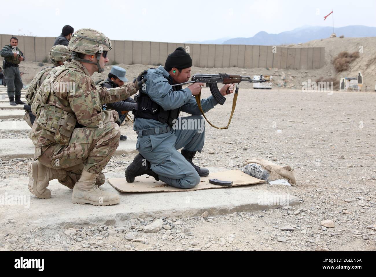 An Afghan Uniformed Policeman, stationed in Khost city, fires his AK-47 ...