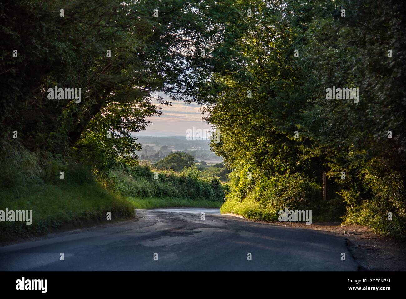Road on the top of farm land hill Stock Photo - Alamy