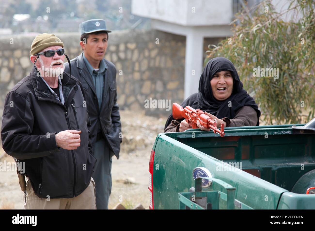 A woman in the Afghan Uniform Police (AUP) takes cover while practicing ...