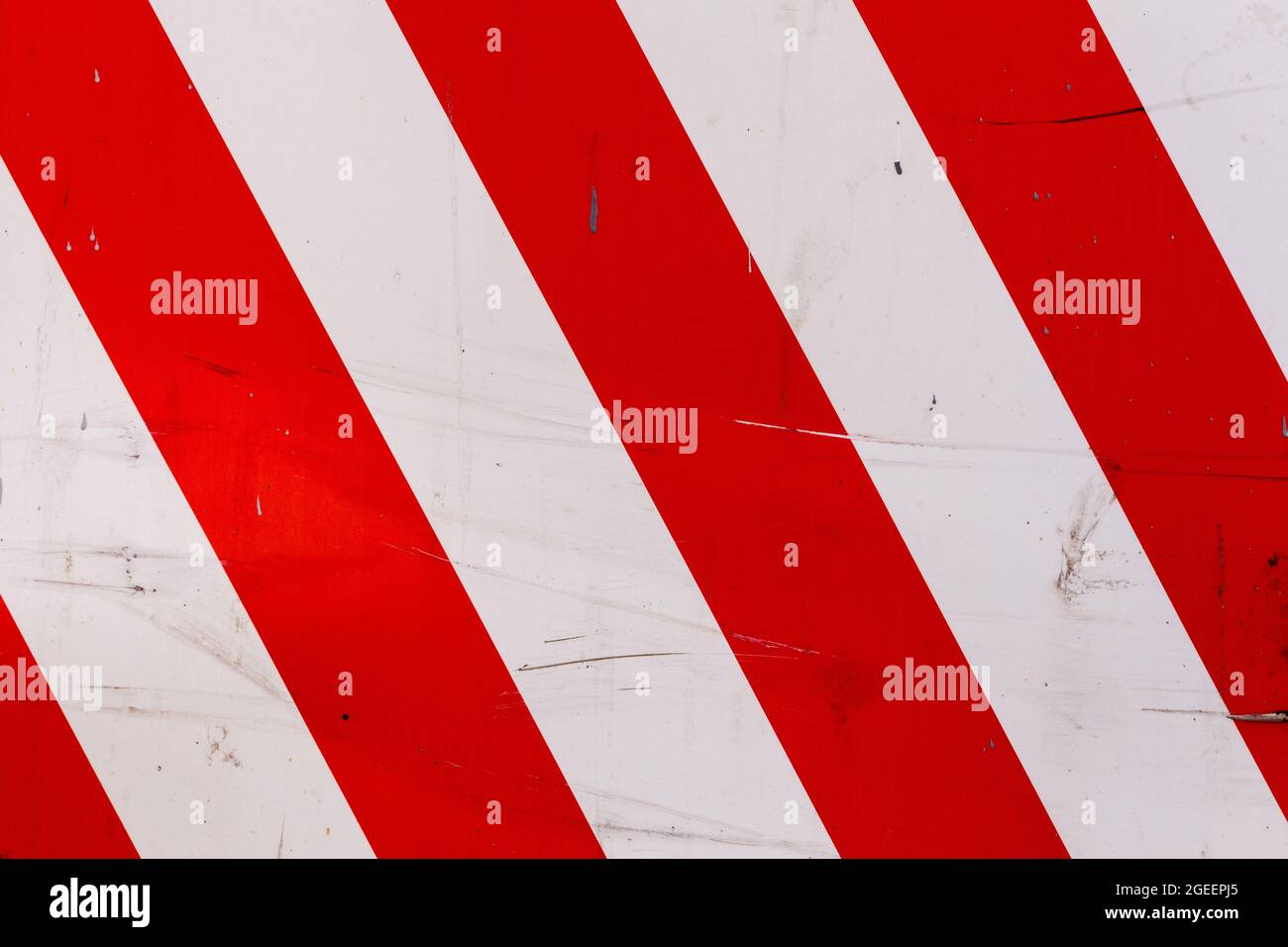 faded red and white diagonal stipes on flat steel sheet - caution road ...