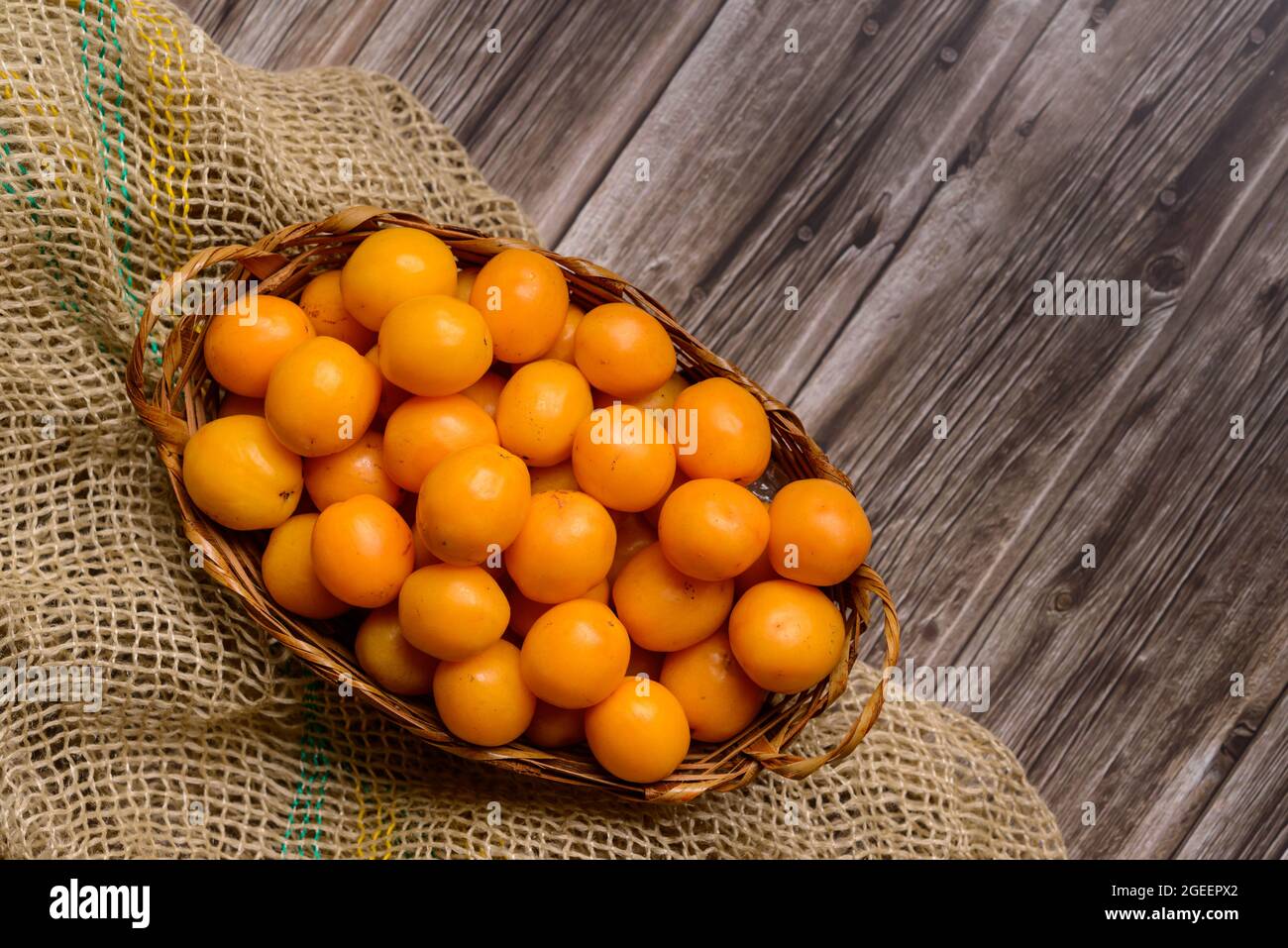 Brazilian fruit caja in the straw basket Stock Photo - Alamy