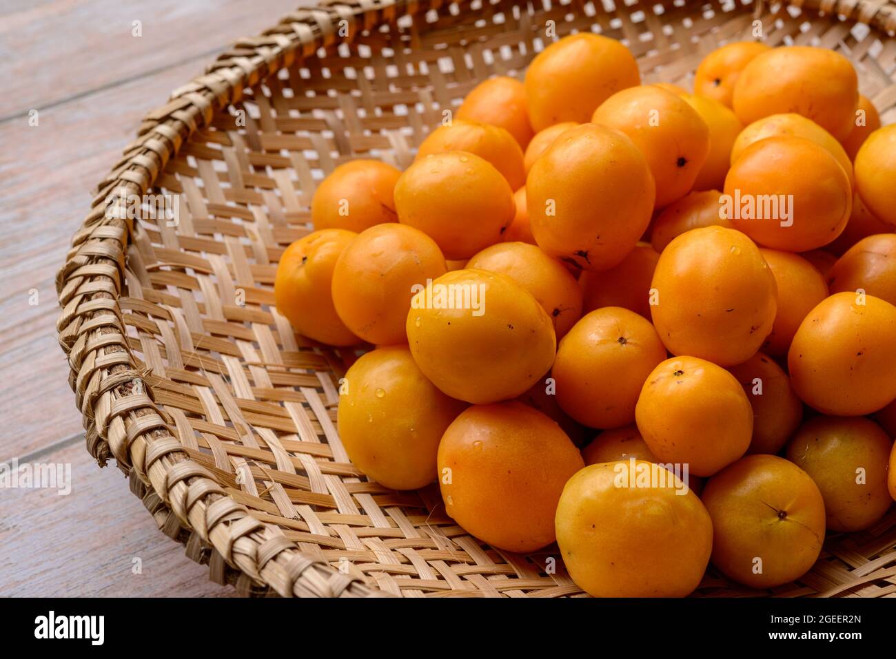 Brazilian fruit caja in the straw basket Stock Photo - Alamy