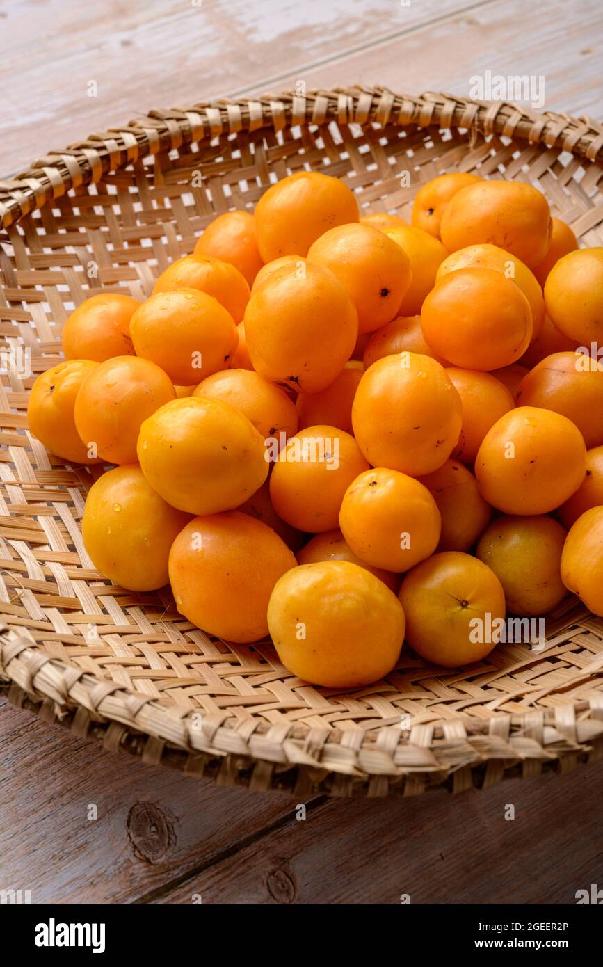 Brazilian fruit caja in the straw basket Stock Photo - Alamy