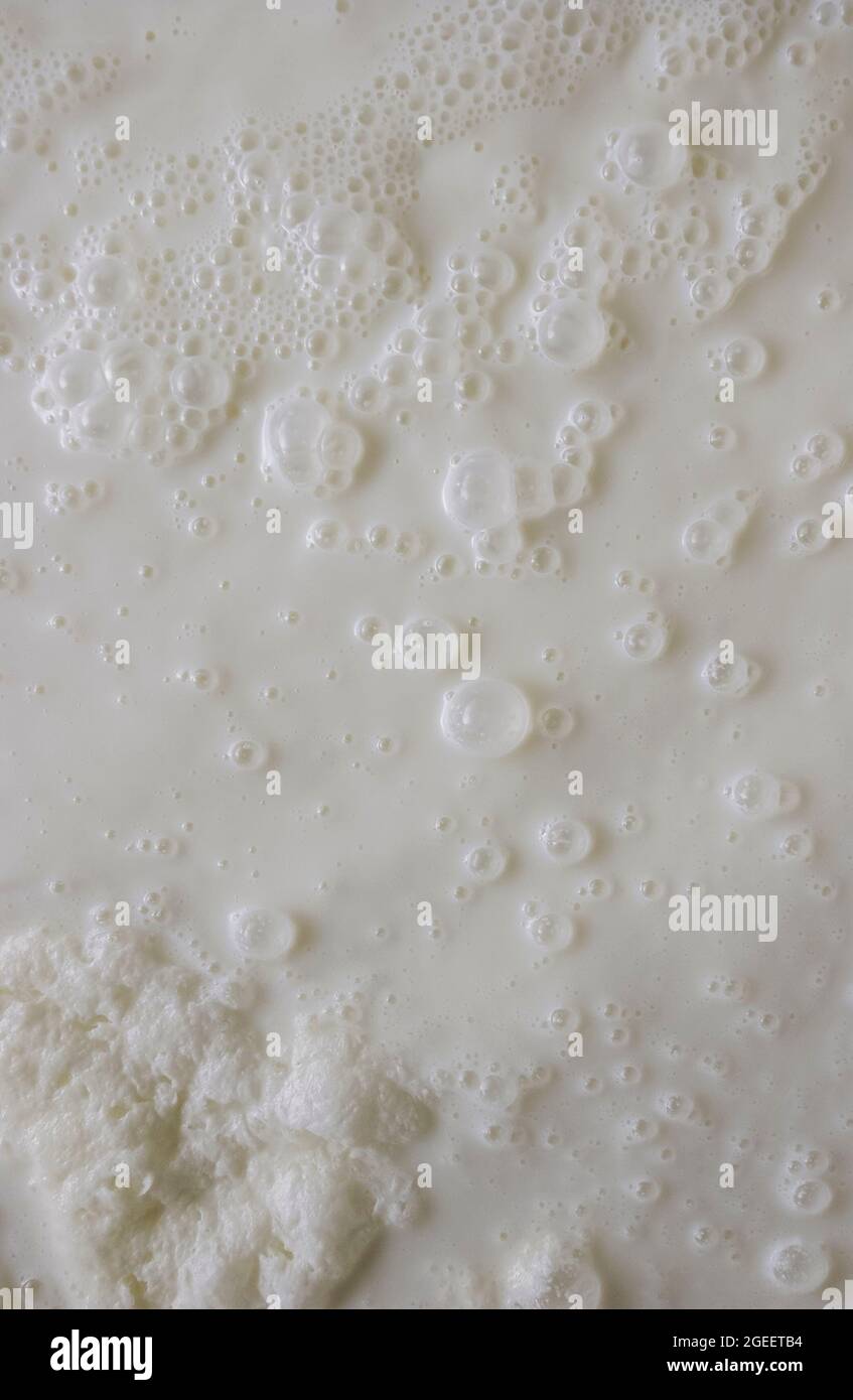 Fresh milk. Bubbles forming scene background Stock Photo - Alamy