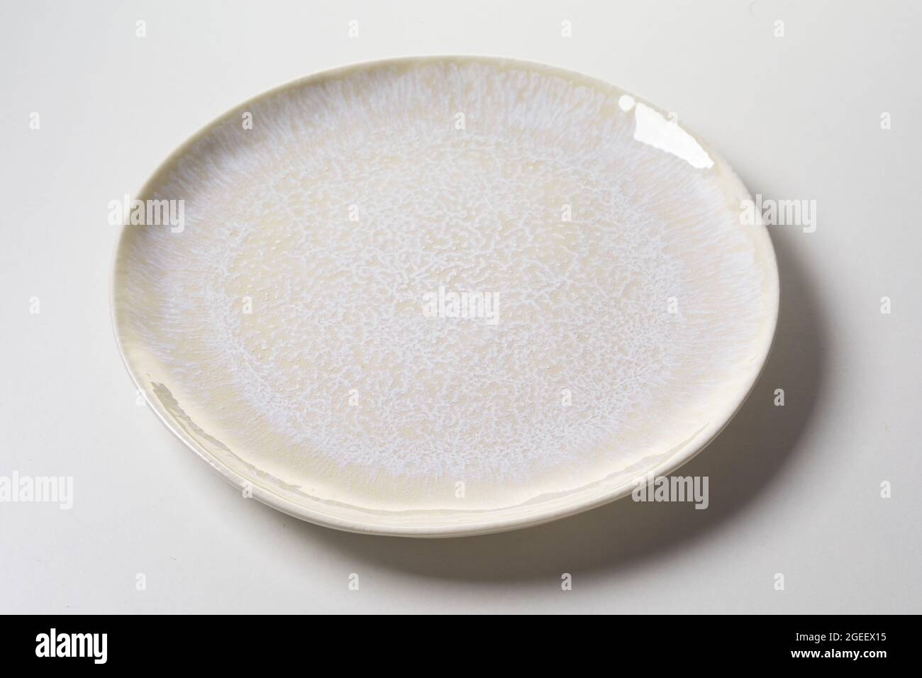 Round ceramic plate covered with shiny enamel with cracks effect on ...