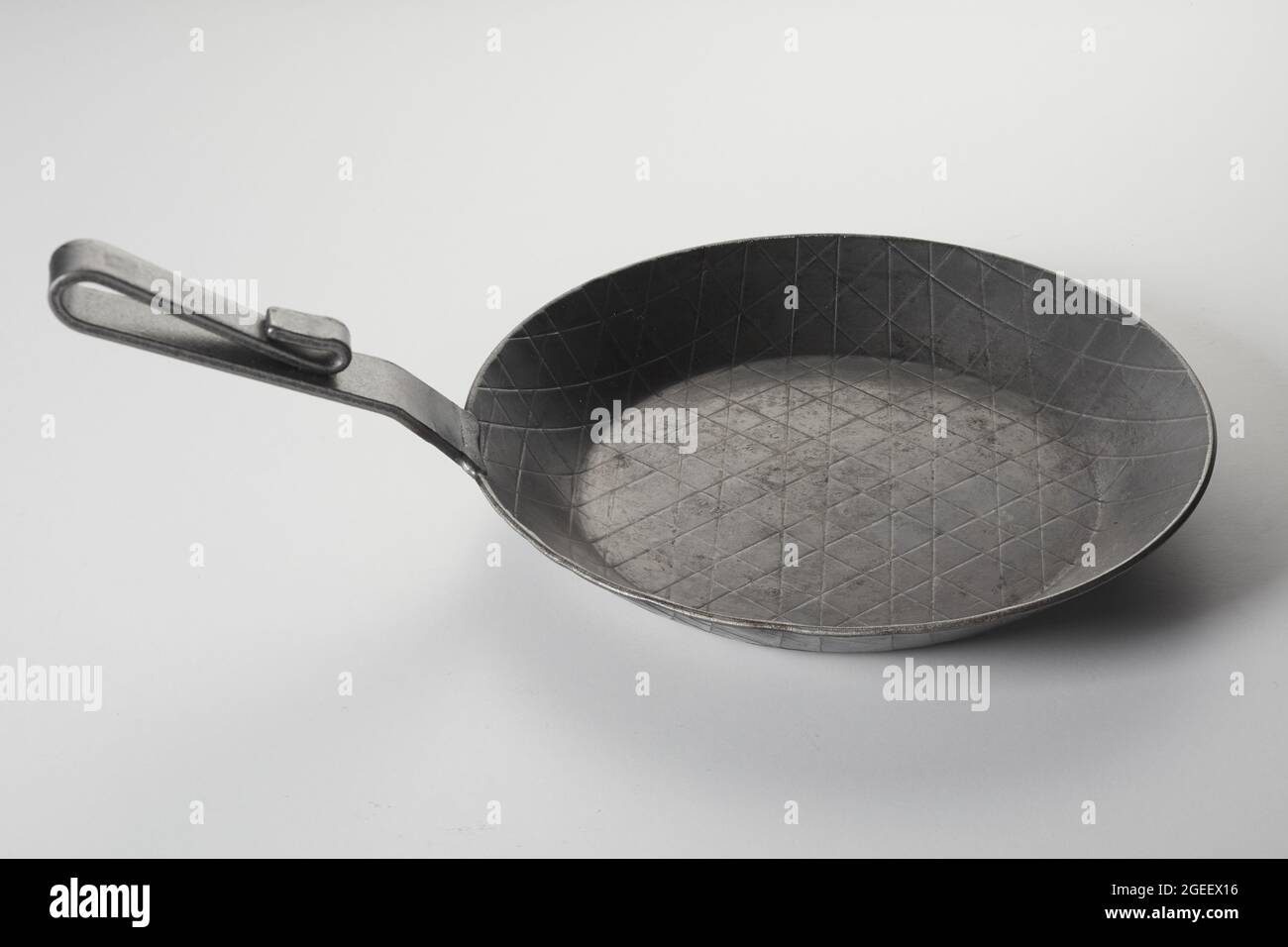 Old shabby black metal frying pan on white background Stock Photo - Alamy