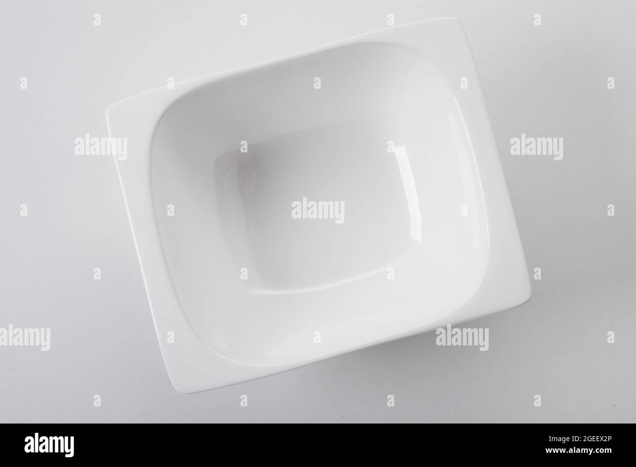 New deep rectangular-shaped white porcelain plate on white background ...