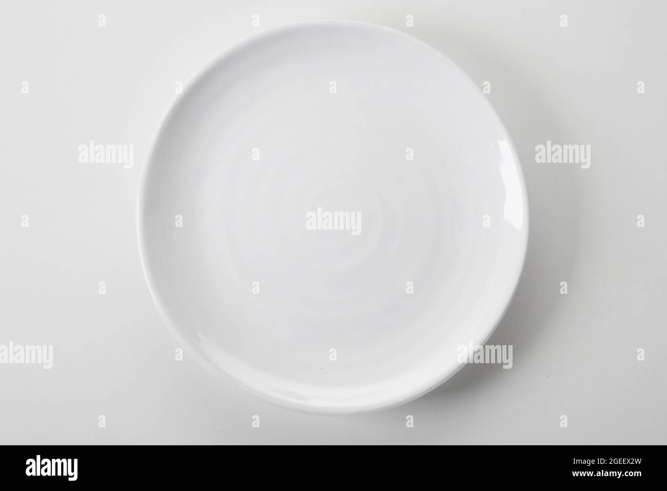 Top view of a new white round shaped ceramic plate in minimalist style on white background Stock ...