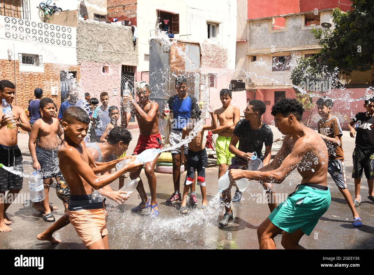 Rabat, Morocco. 19th Aug, 2021. Children play with water on Ashura in ...