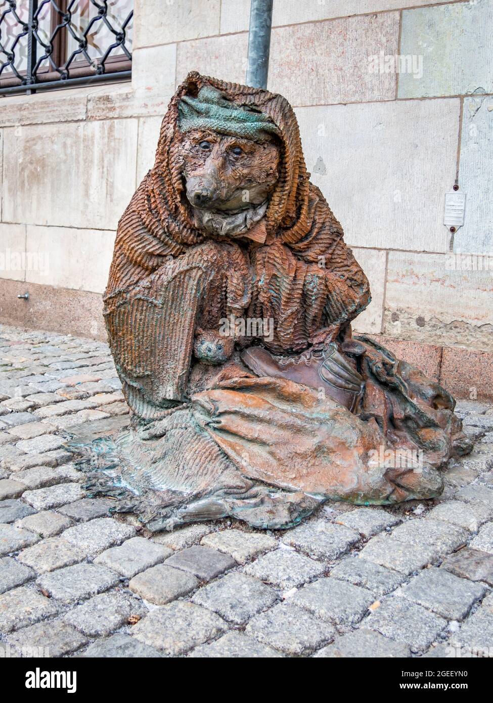 Vertical shot of a statue of an old wise fox in the streets of ...