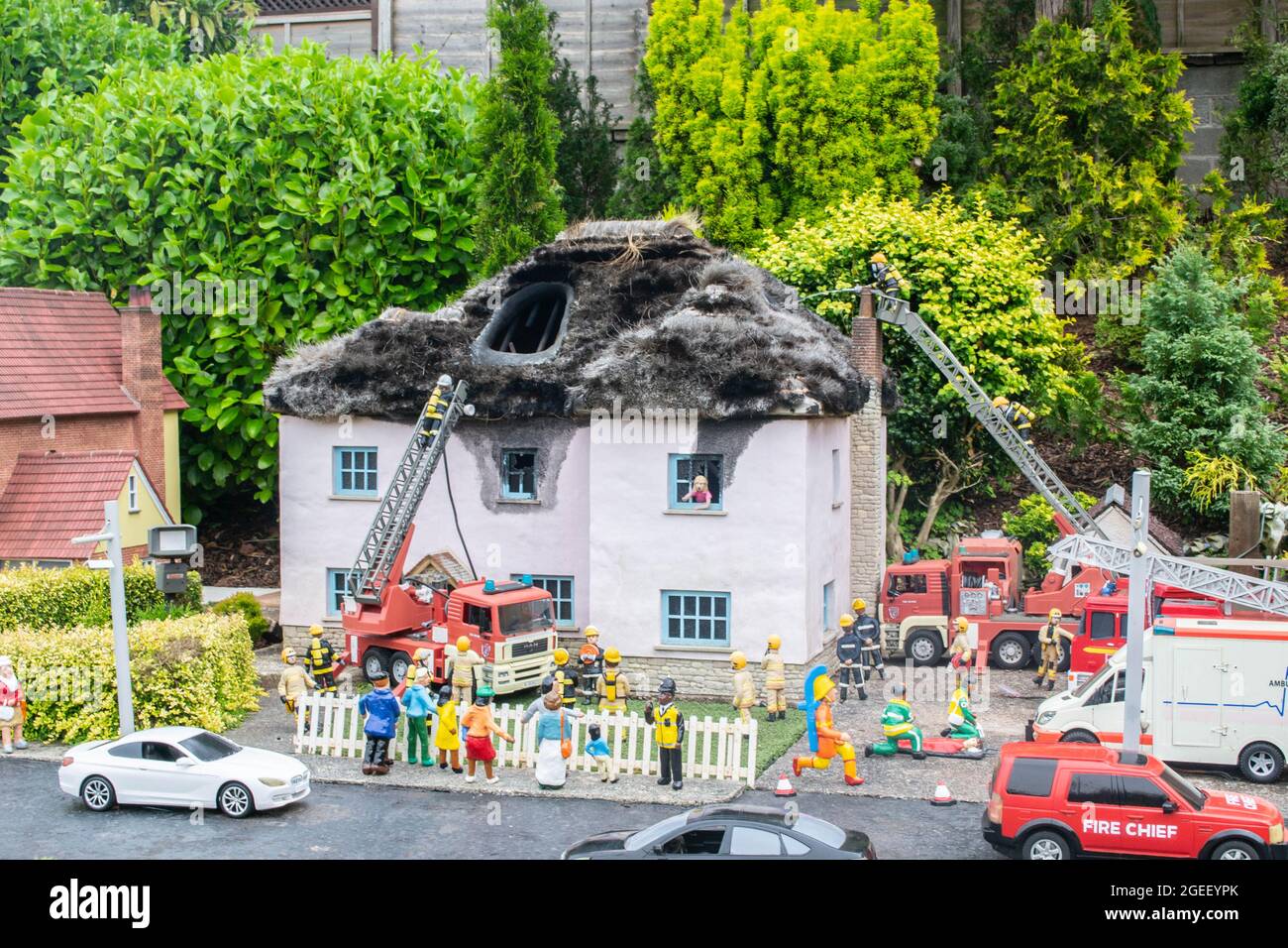 Closeup of tiny model cottage with the roof on fire Stock Photo - Alamy