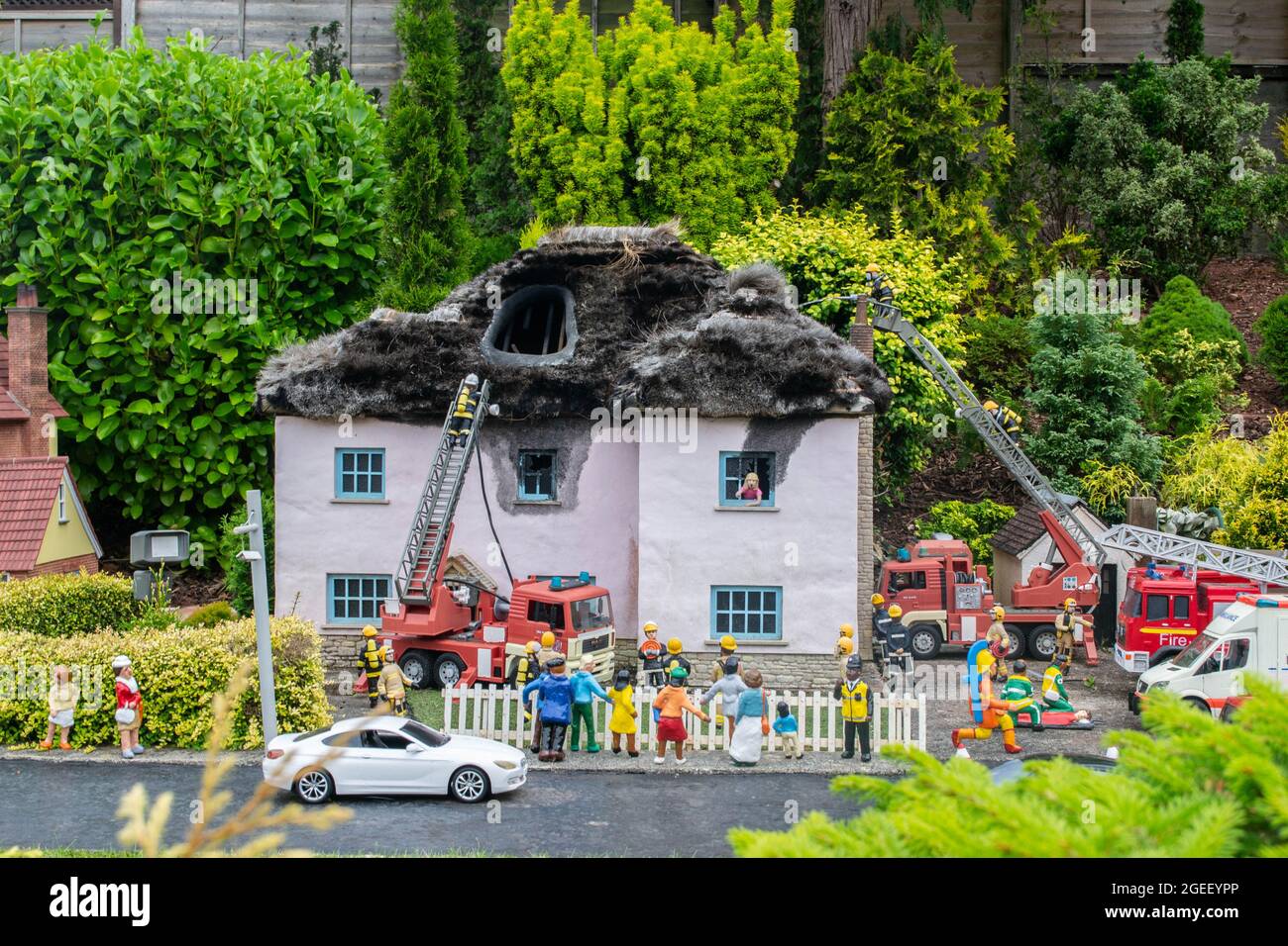 Closeup of tiny model cottage with the roof on fire Stock Photo - Alamy