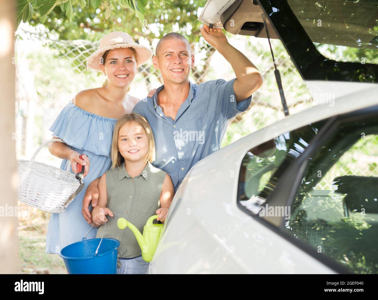 Family standing beside car Stock Photo - Alamy