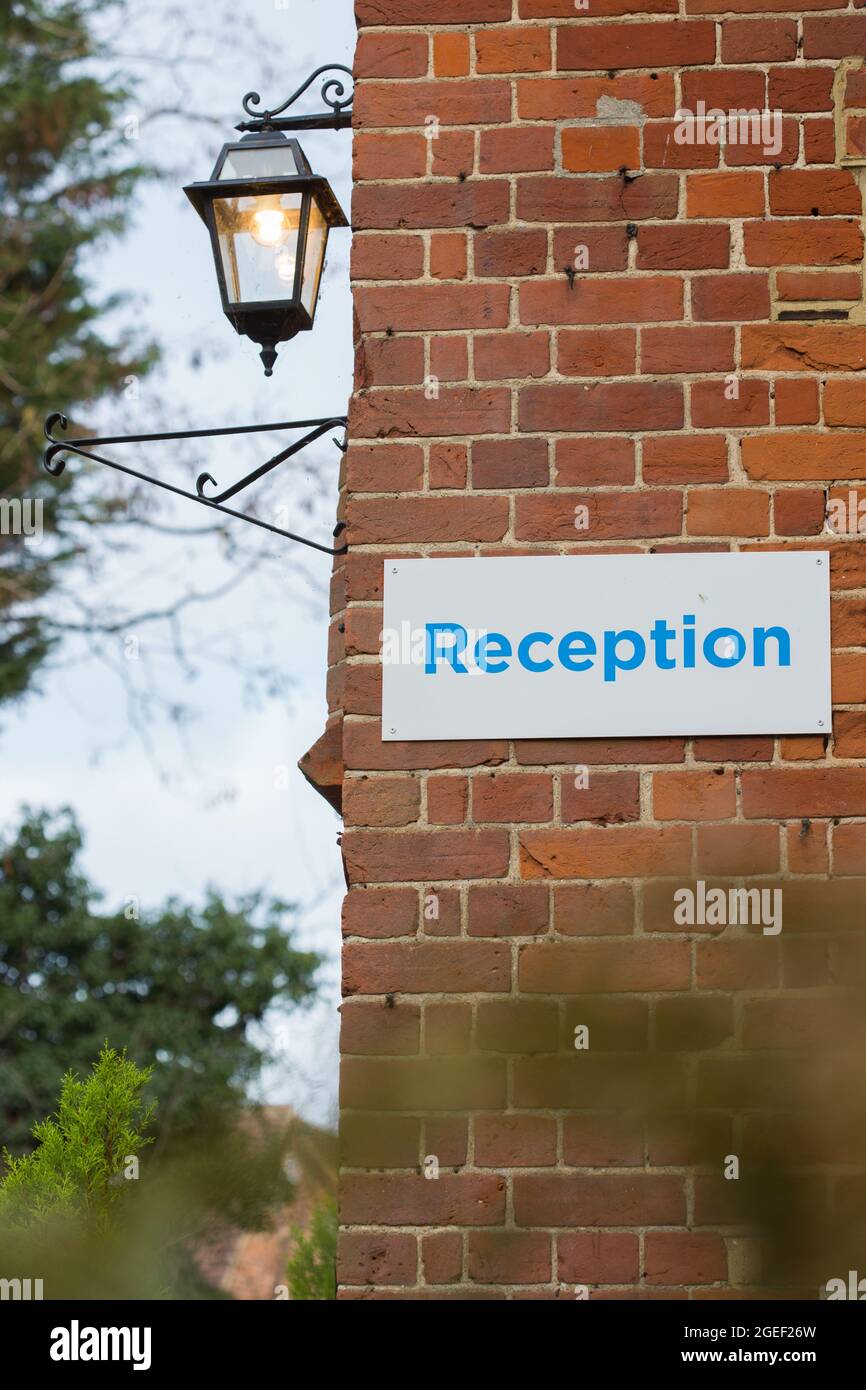 Reception sign on the corner of a brick wall of a building Stock Photo ...