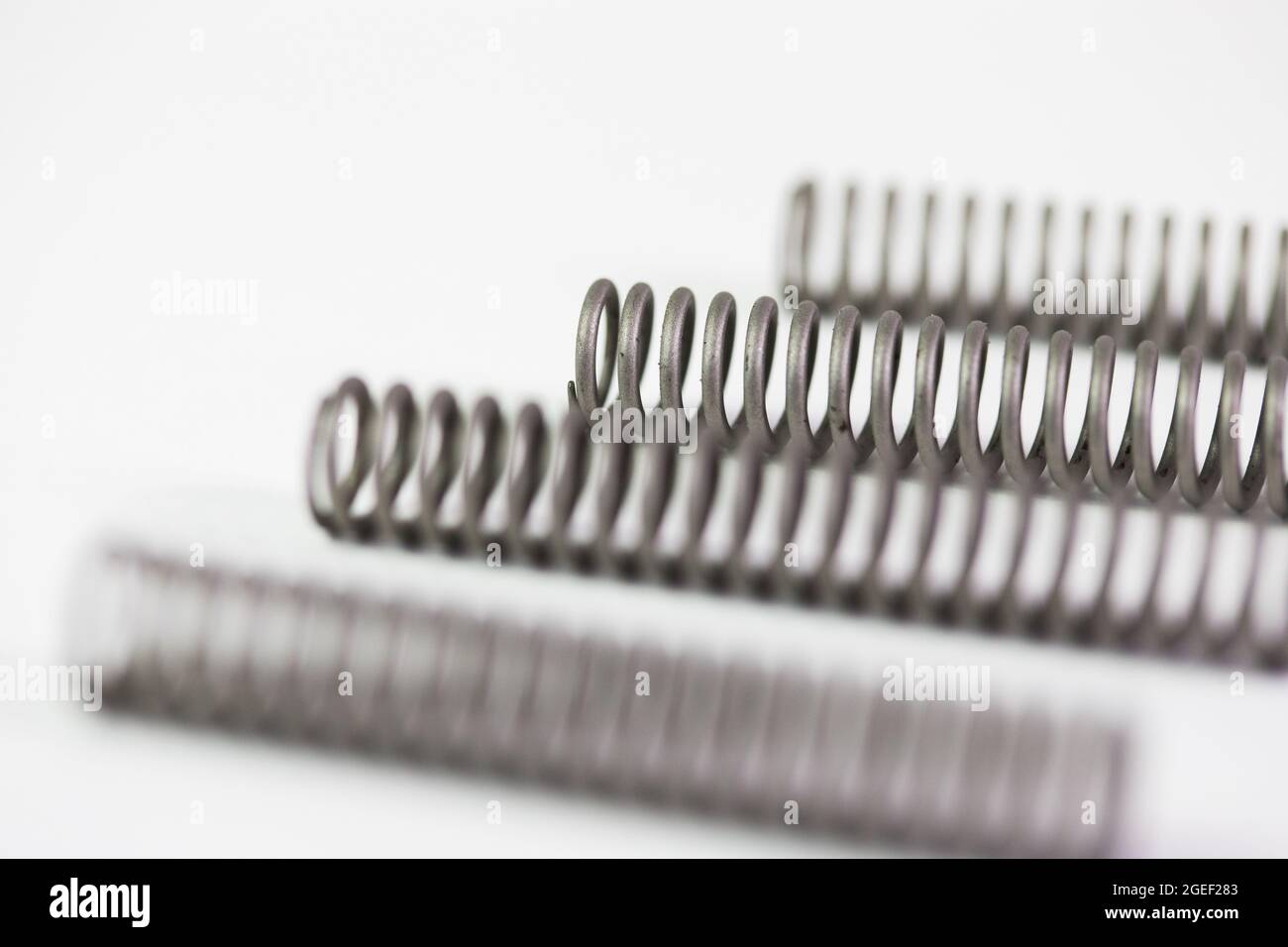 Closeup of metal springs on a white background Stock Photo - Alamy