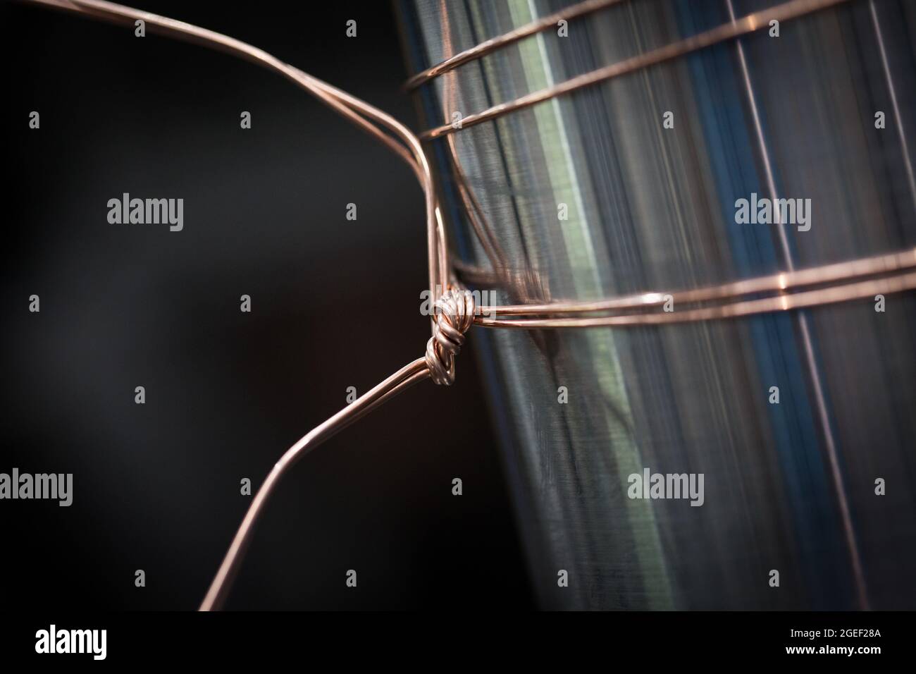 Selective of a metal wire tied on a pipe Stock Photo - Alamy