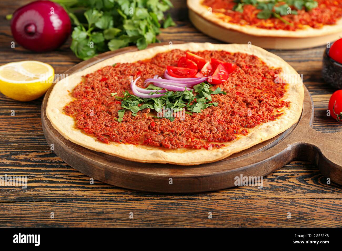 Board with delicious Turkish pizza on wooden background Stock Photo - Alamy
