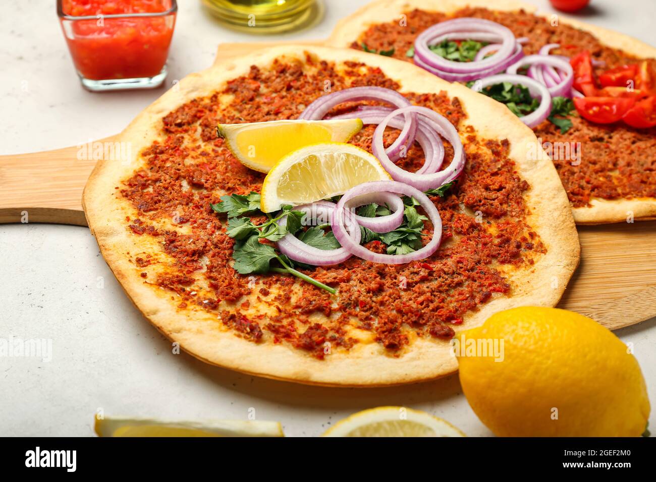 Board with delicious Turkish pizza on light background Stock Photo - Alamy