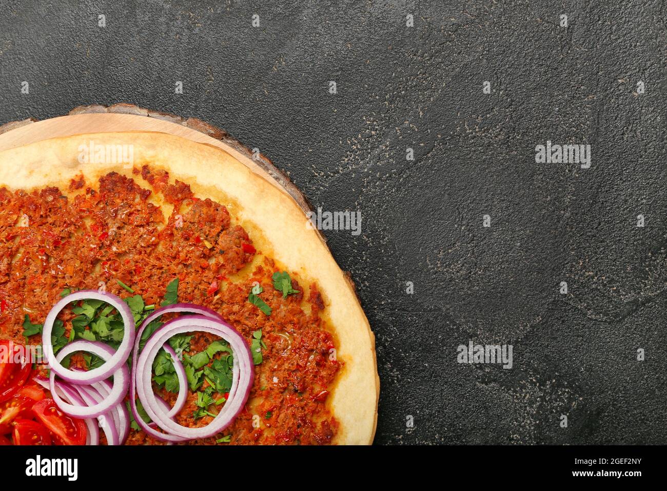 Board with delicious Turkish pizza on dark background Stock Photo - Alamy
