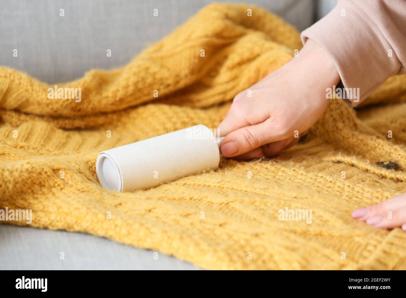 Woman removing her sweater hi-res stock photography and images - Alamy