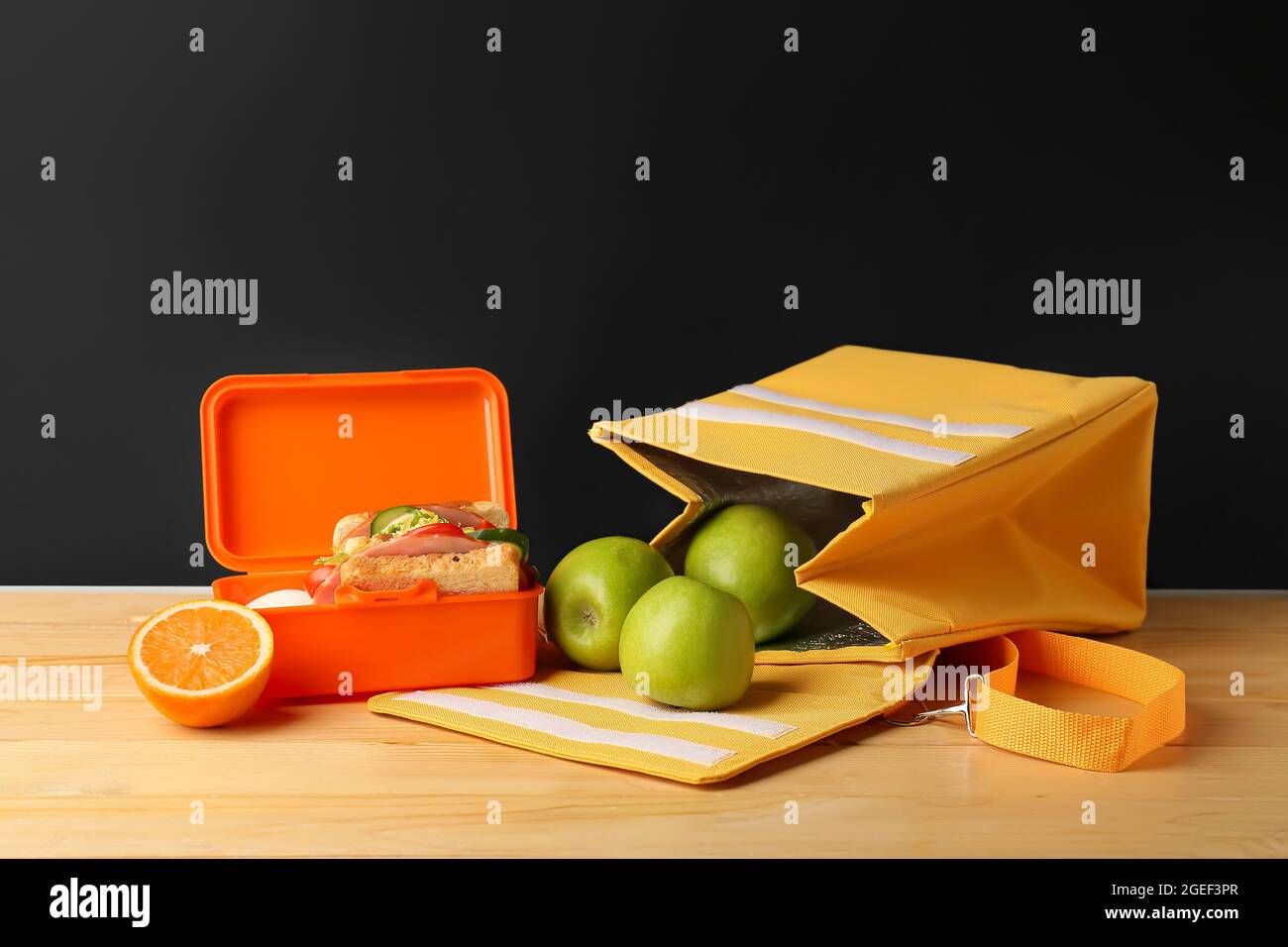 Lunch box with sandwiches and fruits on table in classroom Stock Photo ...