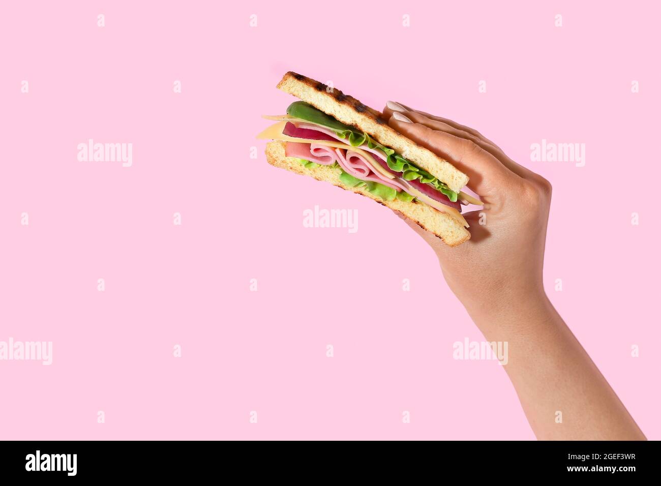 Woman eating bread triangle sandwich hi-res stock photography and ...