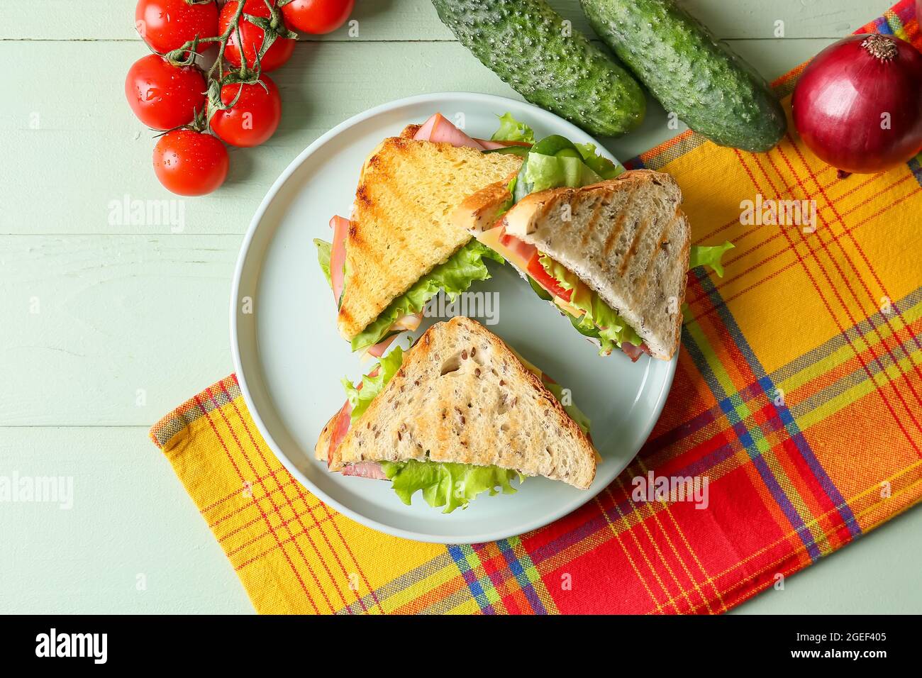 Plate with tasty sandwiches on color wooden background Stock Photo - Alamy