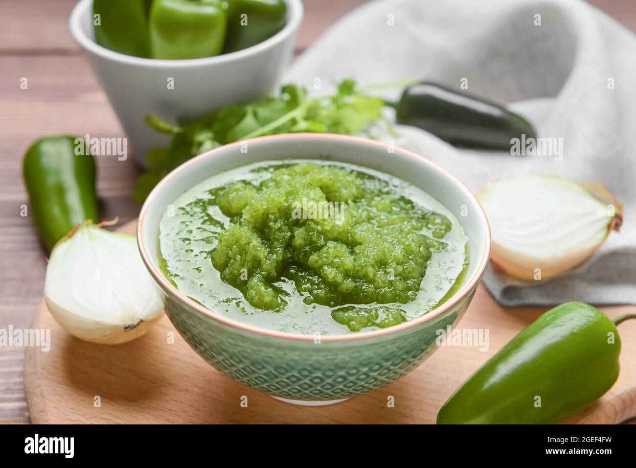 Bowl of Tomatillo Salsa Verde sauce on table Stock Photo - Alamy