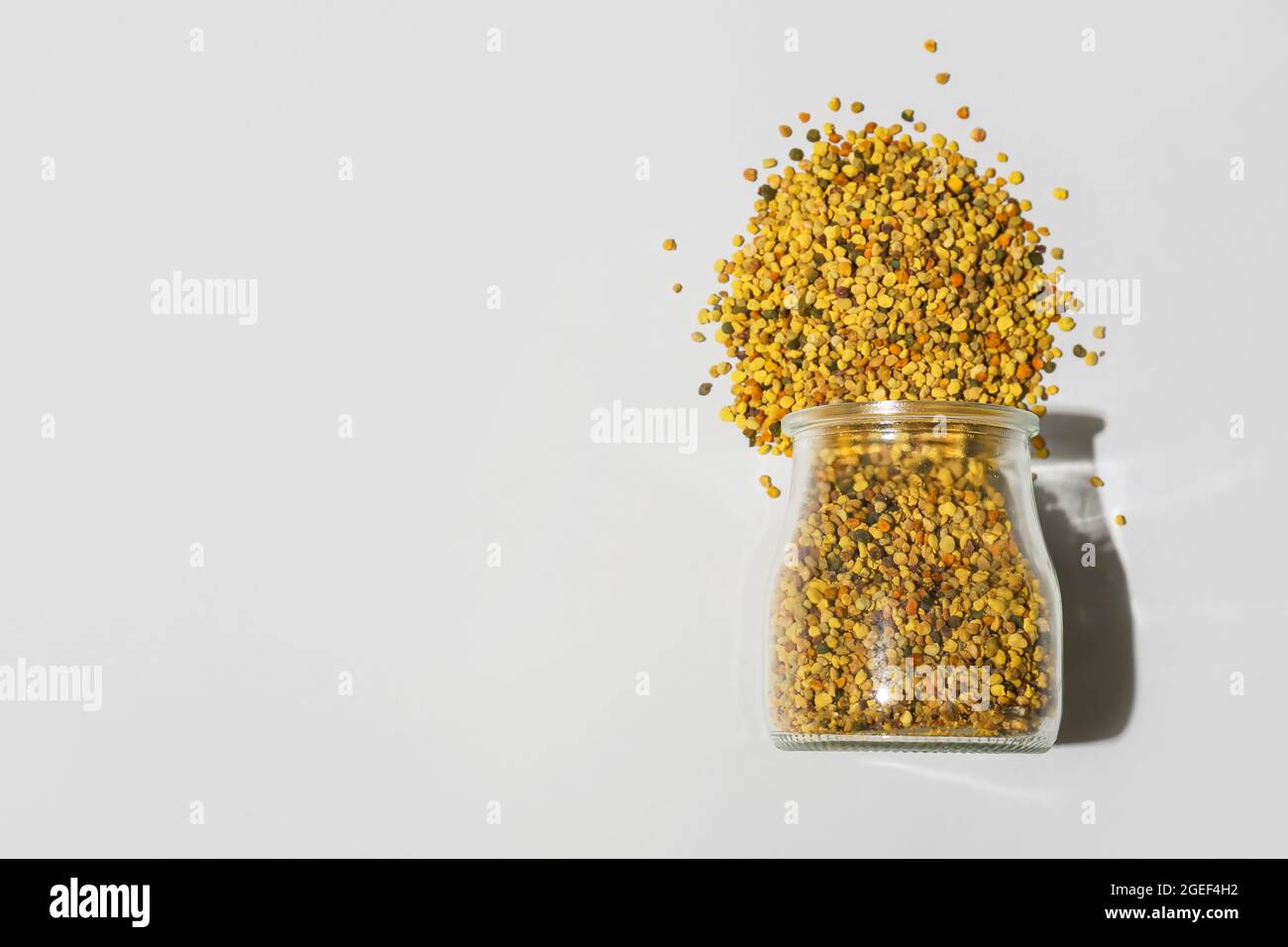 Jar of bee pollen on light background Stock Photo - Alamy