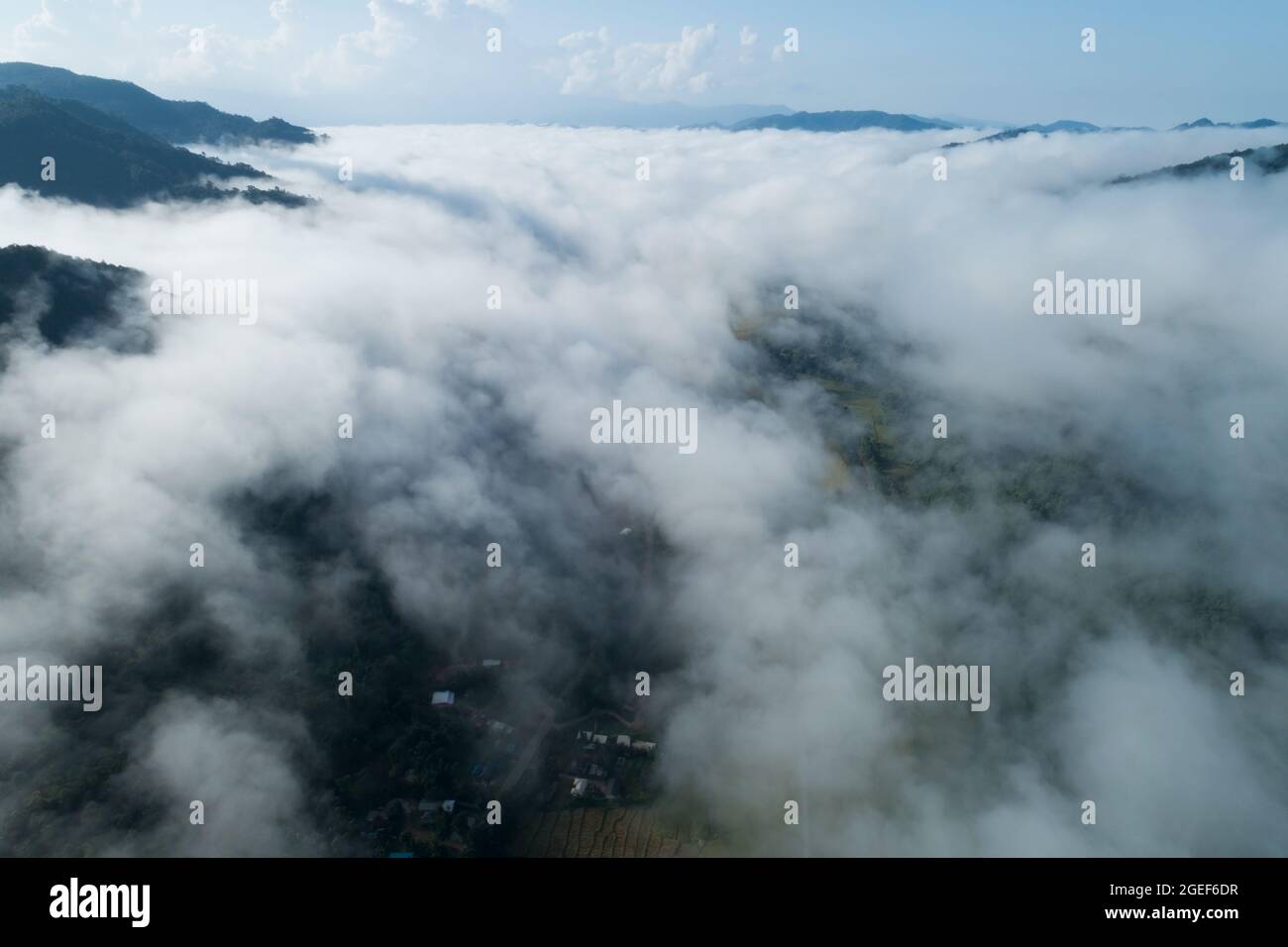 Aerial view drone shot of flowing fog waves on mountain tropical ...
