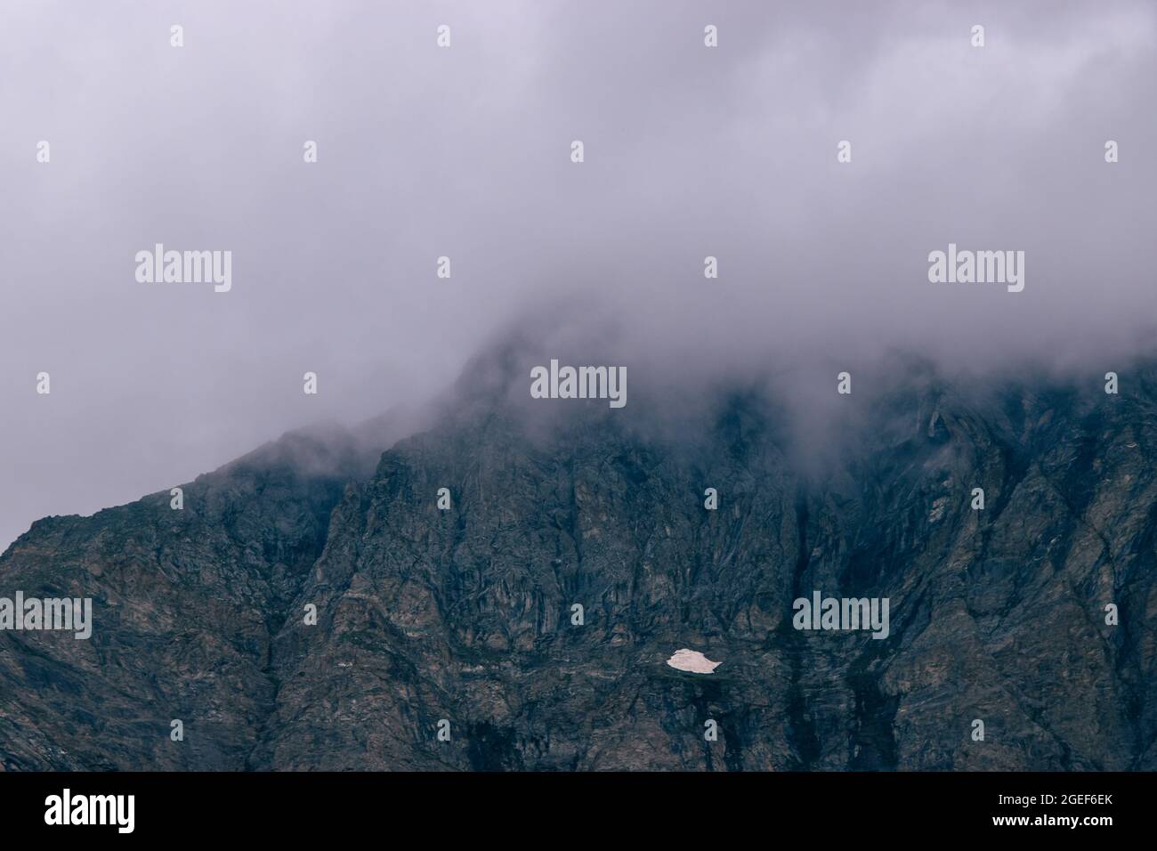 Rocks covered by dense fog in the Gran Paradiso National Park in ...