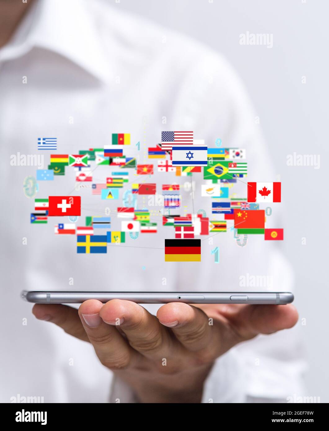 Hand holding a phone with a floating network of international flag ...