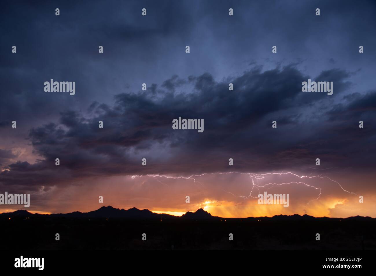 Lightning storm over the desert at sunset Stock Photo - Alamy