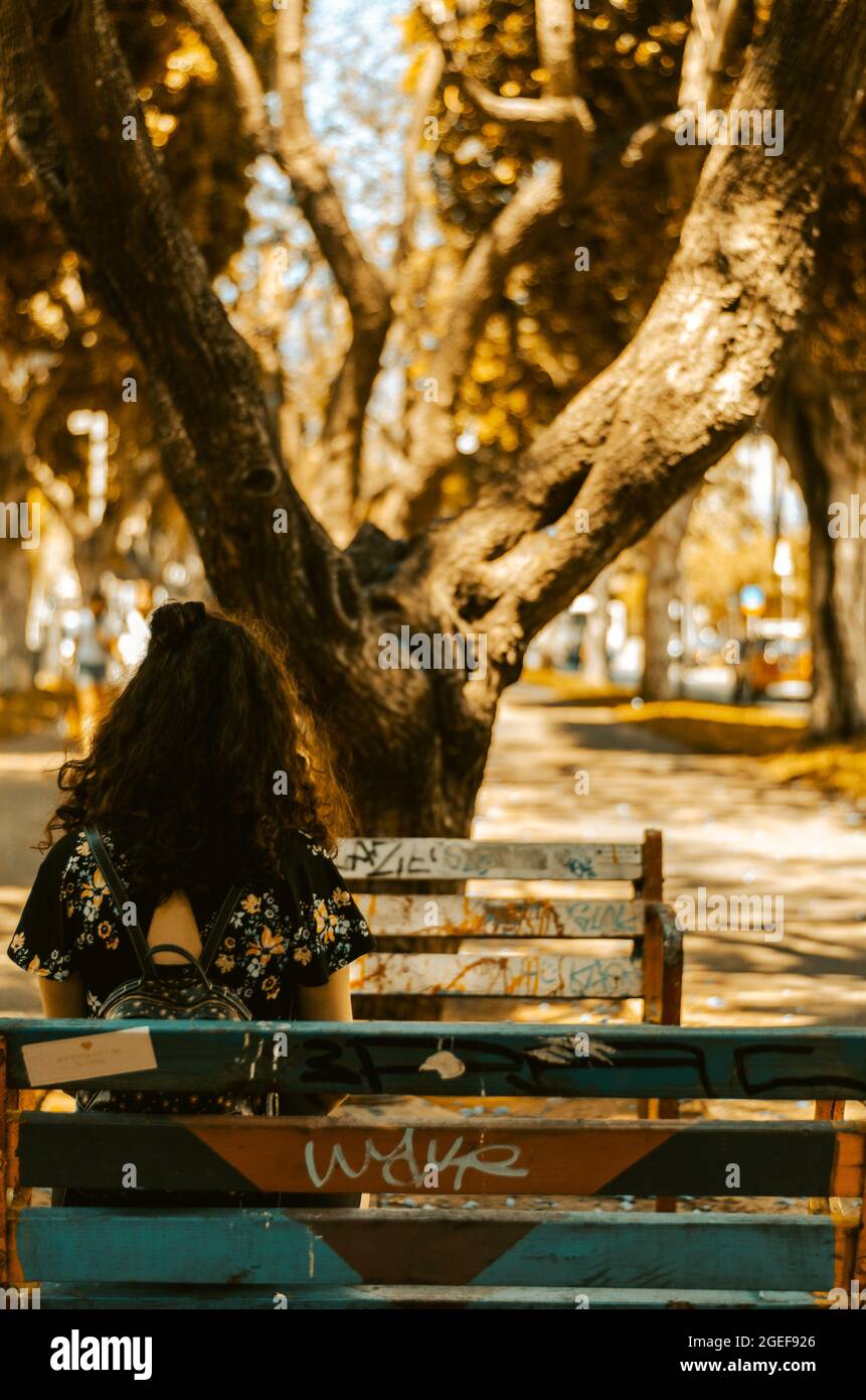 ROSH PINNA, ISRAEL - May 25, 2021: A rear view of a lonely curly woman ...
