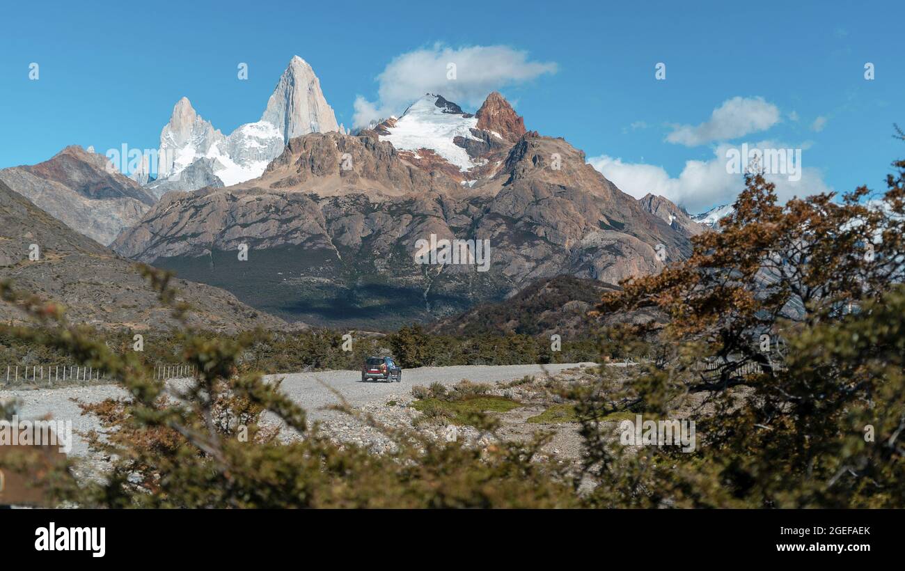 Car going through a stone road, mount fitz roy behind Stock Photo - Alamy